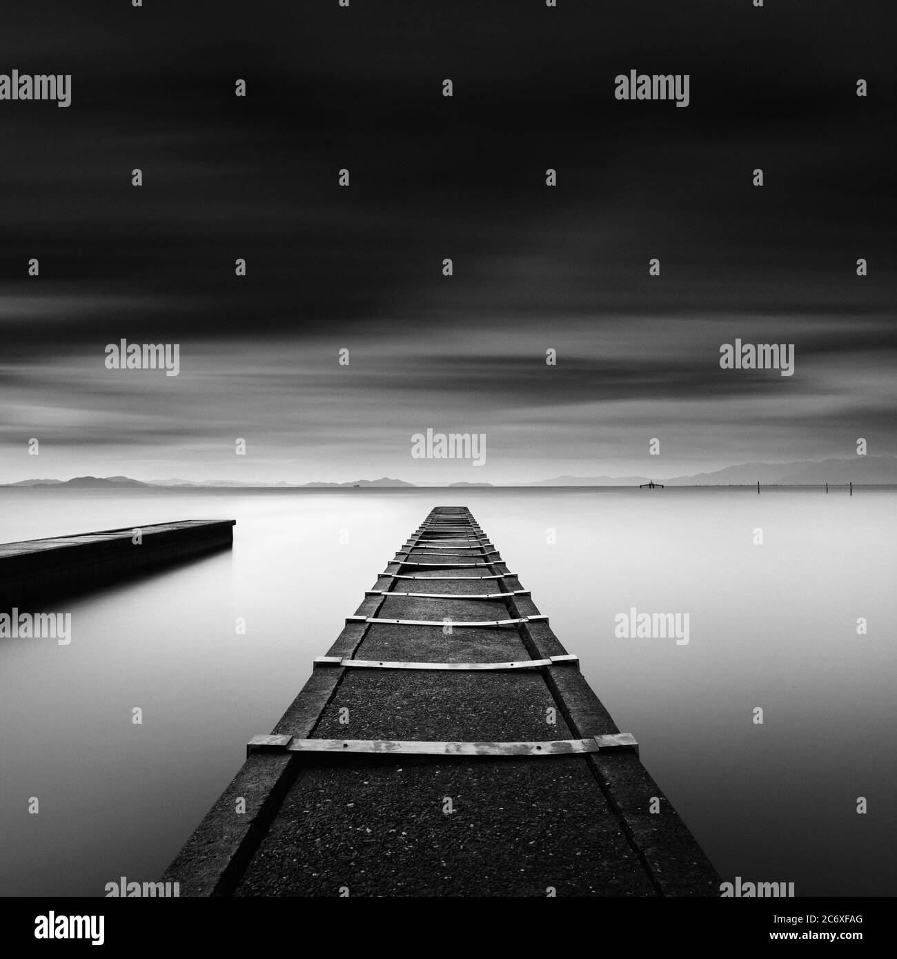 Long exposure shot of jetty and dramatic clouds, Lake Biwa, Shiga ...