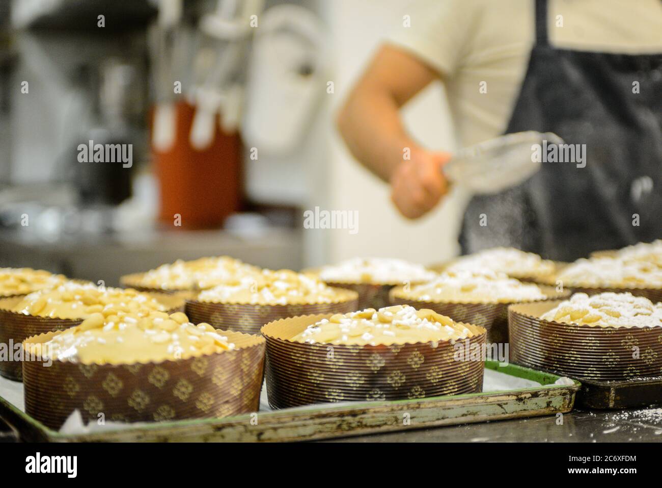 Chef baker adding sugar preparing panettone italian cake in bakery ...