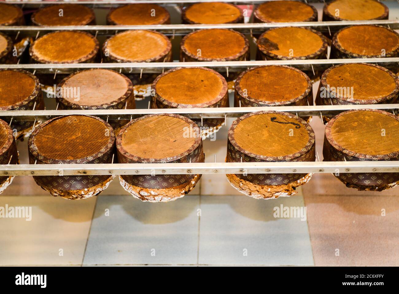 hanging upside down panettone xmas cakes to finish preparation oven ...