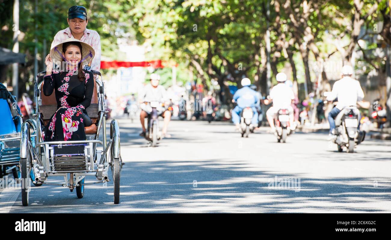 Woman sitting on a rickshaw in Hue / Vietnam Stock Photo - Alamy