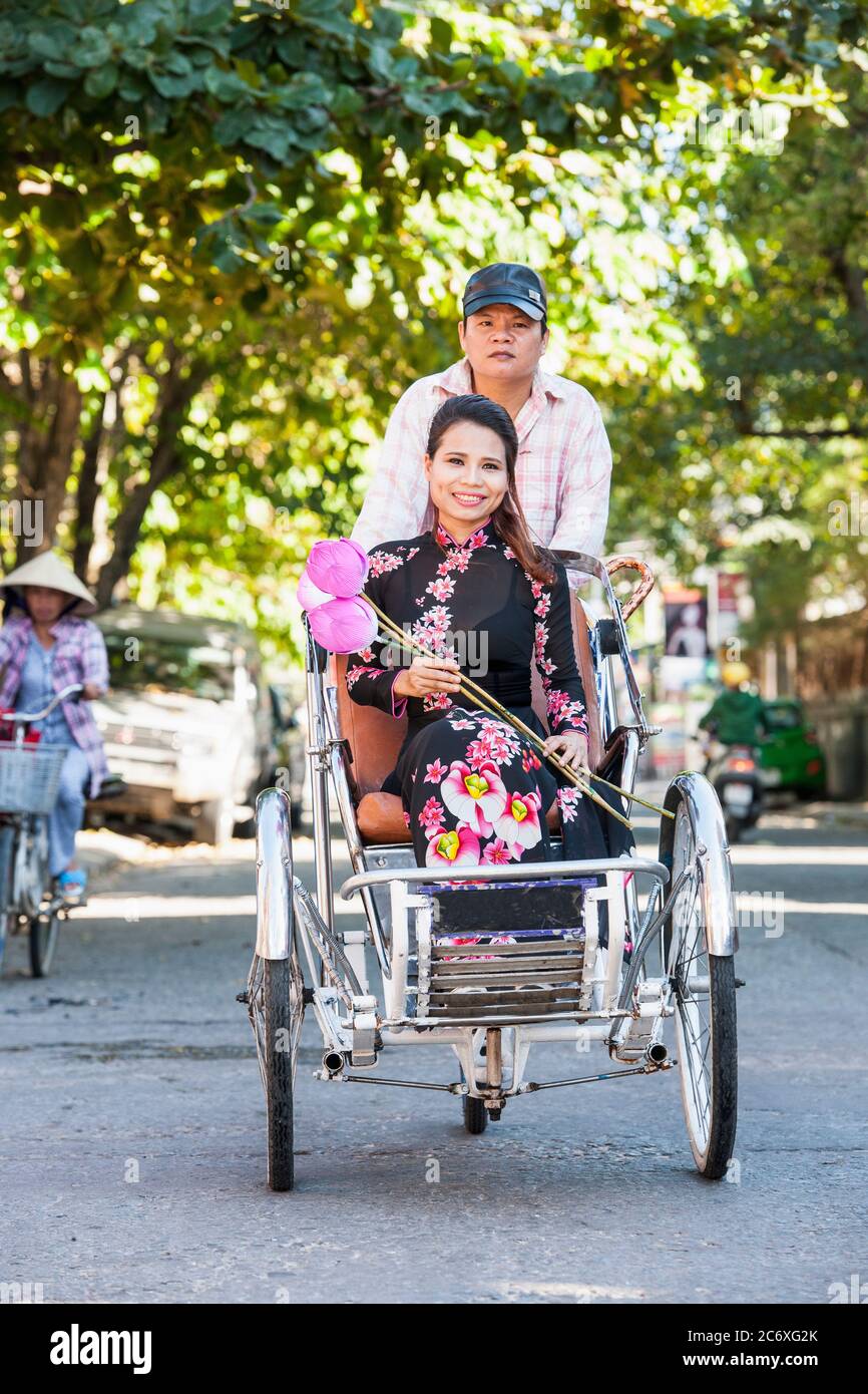 Woman sitting on a rickshaw in Hue / Vietnam Stock Photo - Alamy