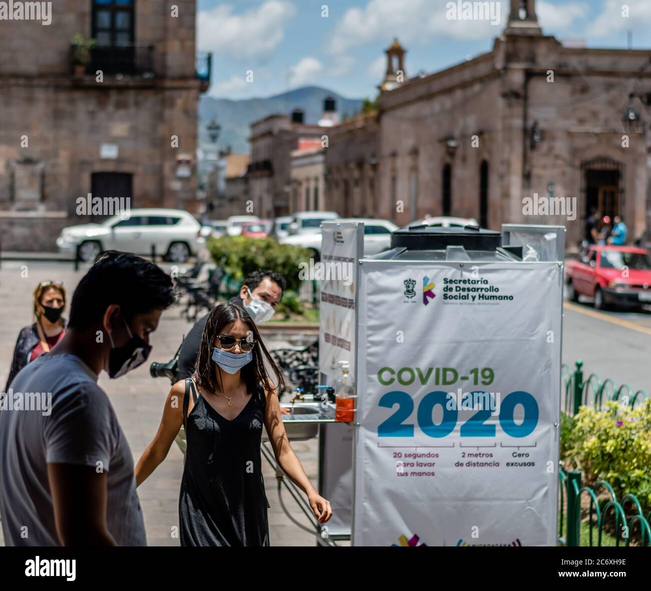 Hispanic people washing hands before entering store in Morelia Mexico ...