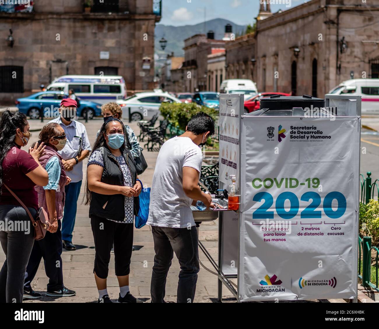 Hispanic people washing hands before entering store in Morelia Mexico ...