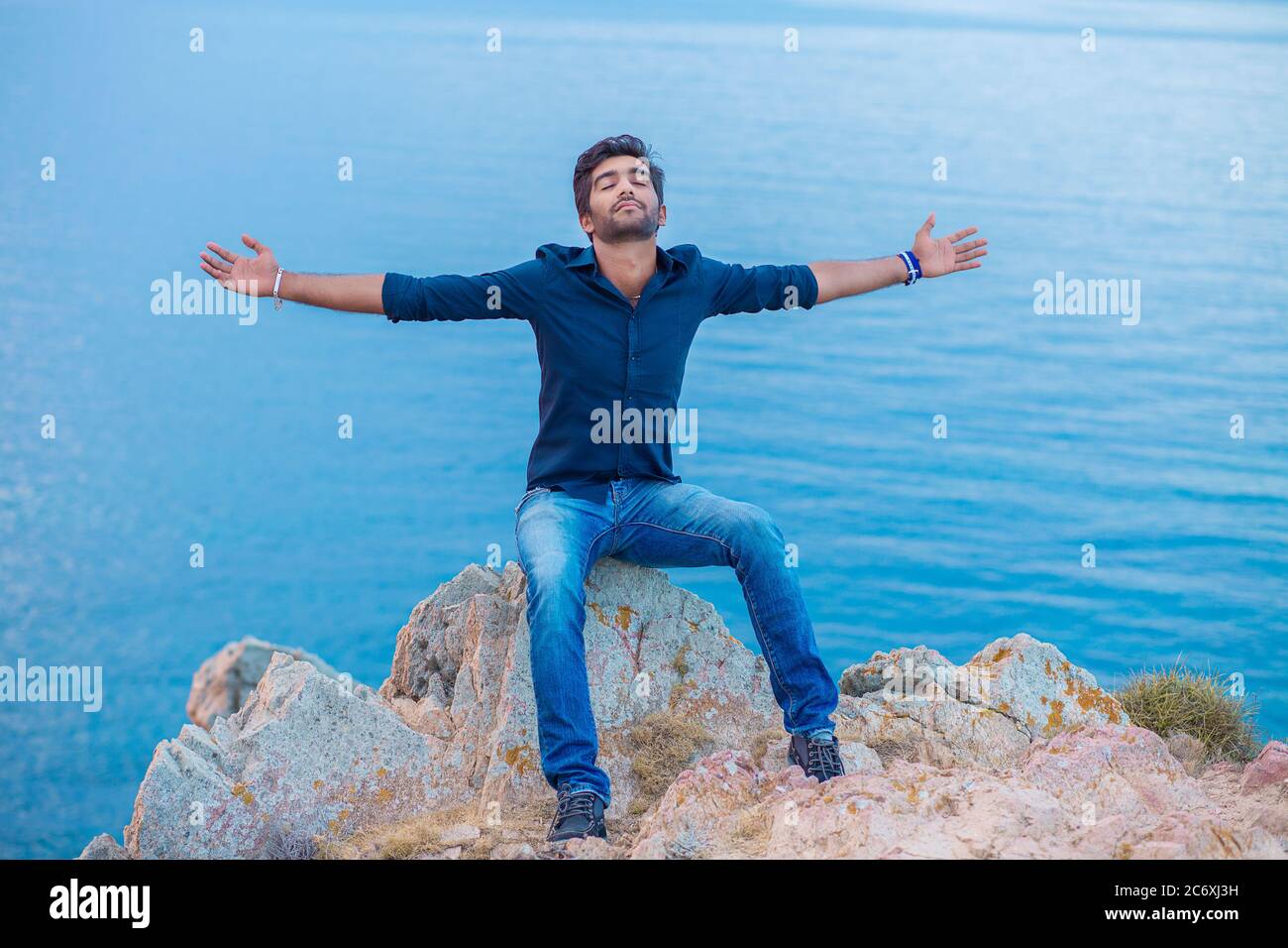 Man smiling looking up to blue sky taking deep breath celebrating ...