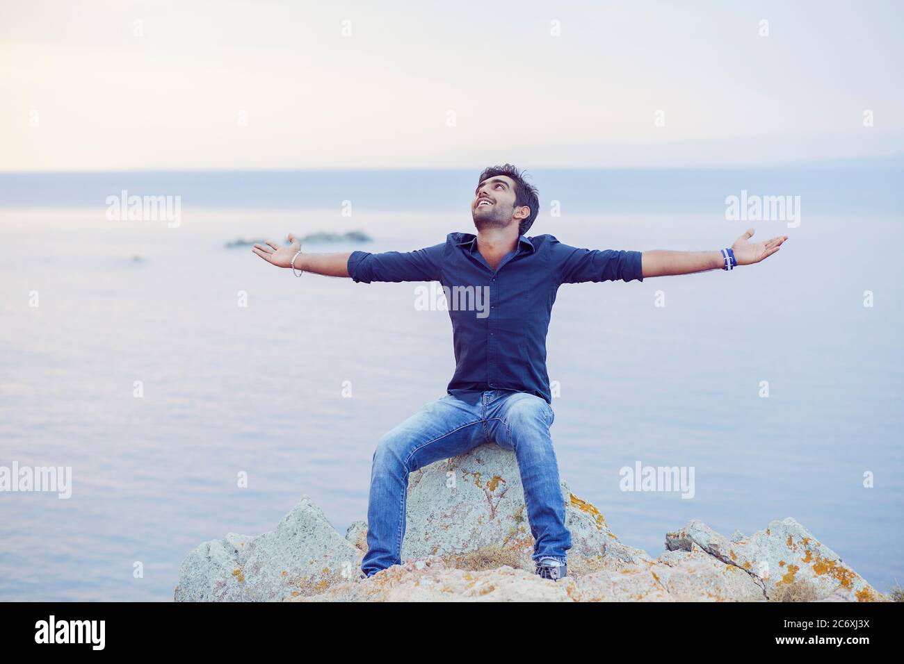 Man smiling looking up to blue sky taking deep breath celebrating ...