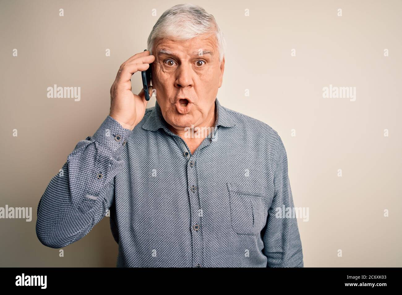 Senior hoary man having conversation talking on the smartphone over ...