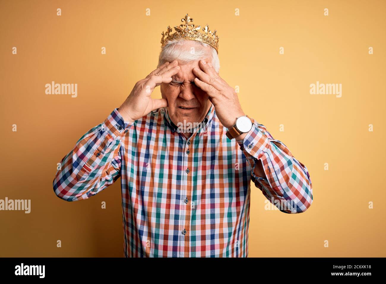 Senior handsome hoary man wearing golden crown of king over isolated ...