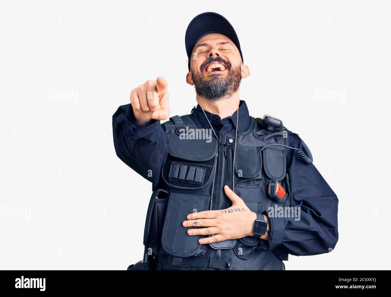 Young handsome man wearing police uniform laughing at you, pointing ...