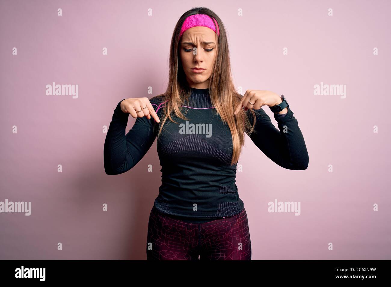 Young blonde fitness woman wearing sport workout clothes over isolated ...