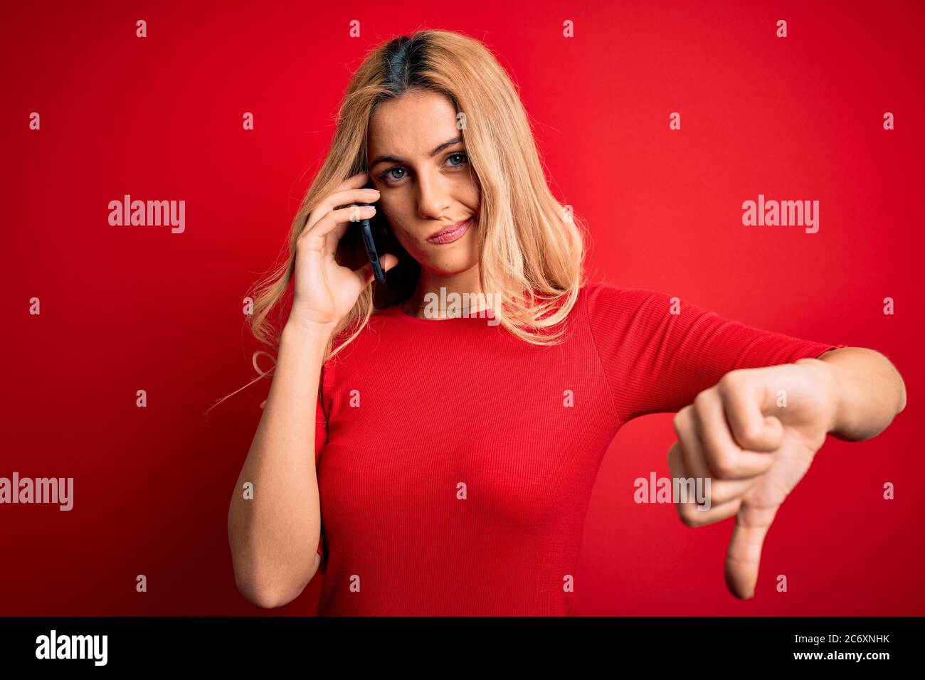 Beautiful blonde woman having conversation talking on the smartphone ...