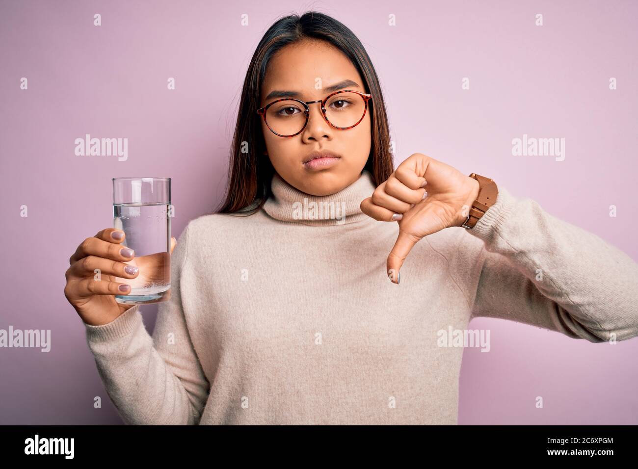 Young asian girl drinking glass of water to refreshment over isolated ...