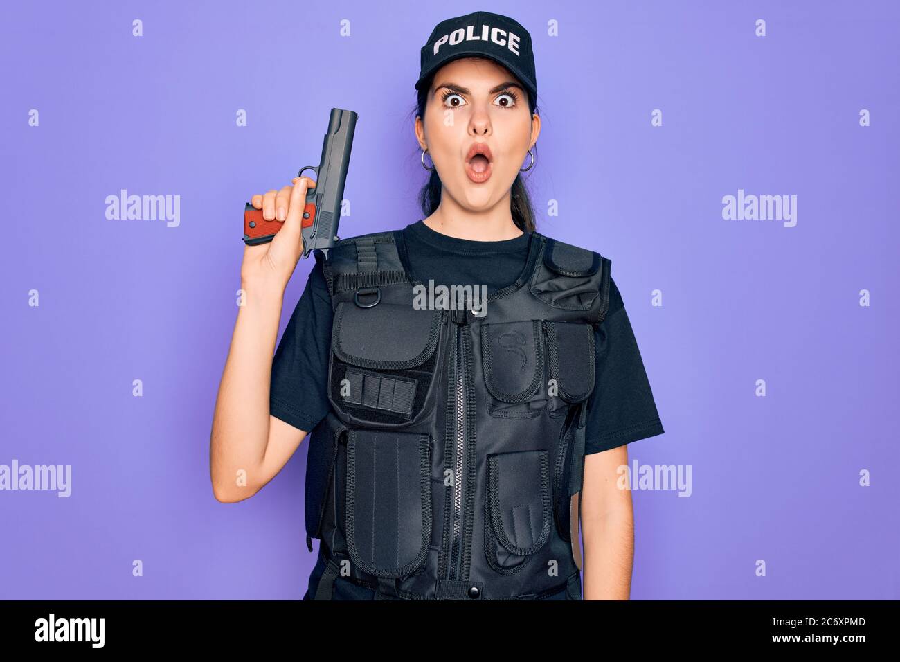Young police woman wearing security bulletproof vest uniform and ...