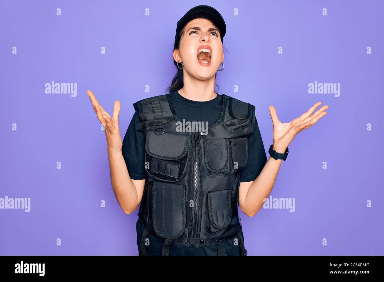 Young police woman wearing security bulletproof vest uniform over ...