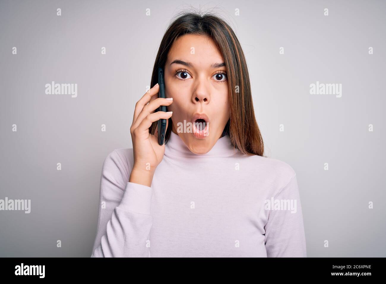 Beautiful brunette girl having conversation talking on the smartphone ...