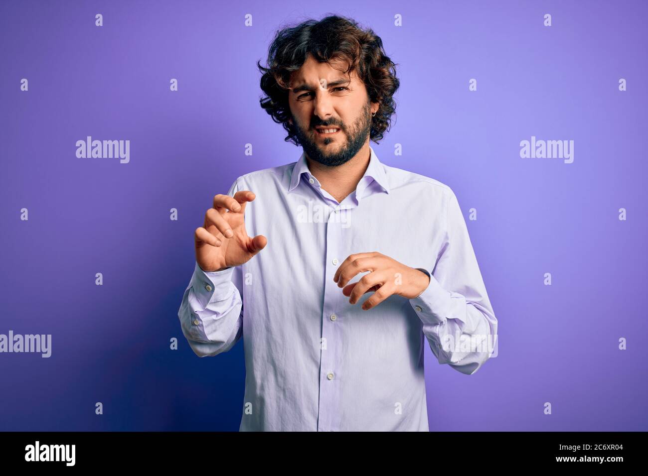 Young handsome business man with beard wearing shirt standing over ...