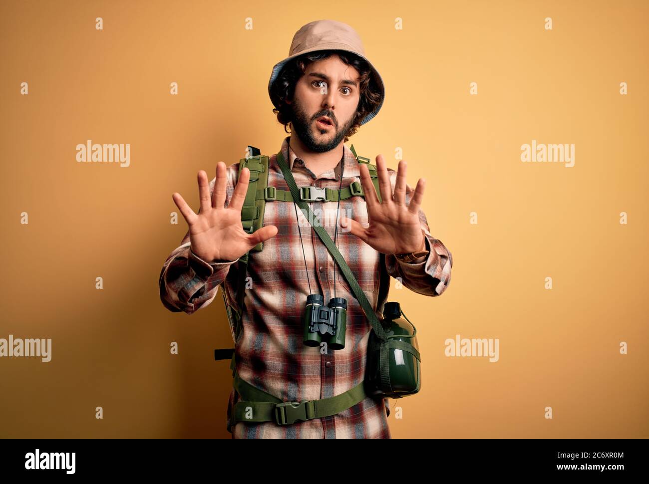 Young hiker man with curly hair and beard hiking wearing backpack and ...