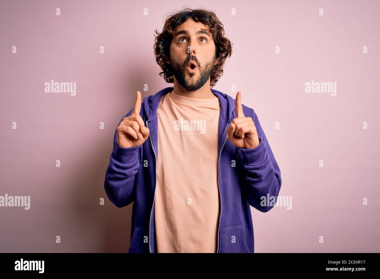 Young handsome sporty man with beard wearing casual sweatshirt over ...