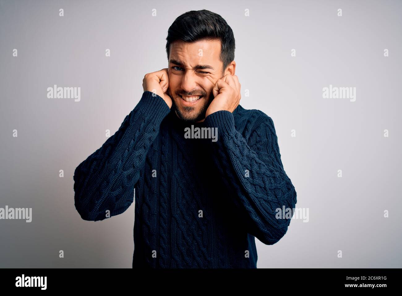 Young handsome man with beard wearing casual sweater standing over ...
