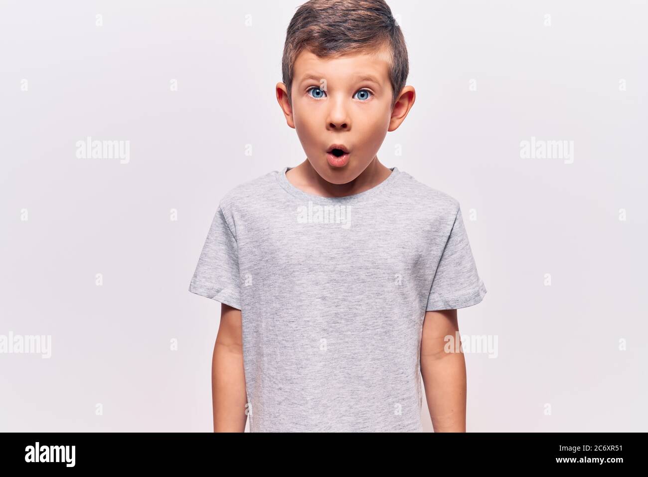 Cute blond kid wearing casual clothes scared and amazed with open mouth ...