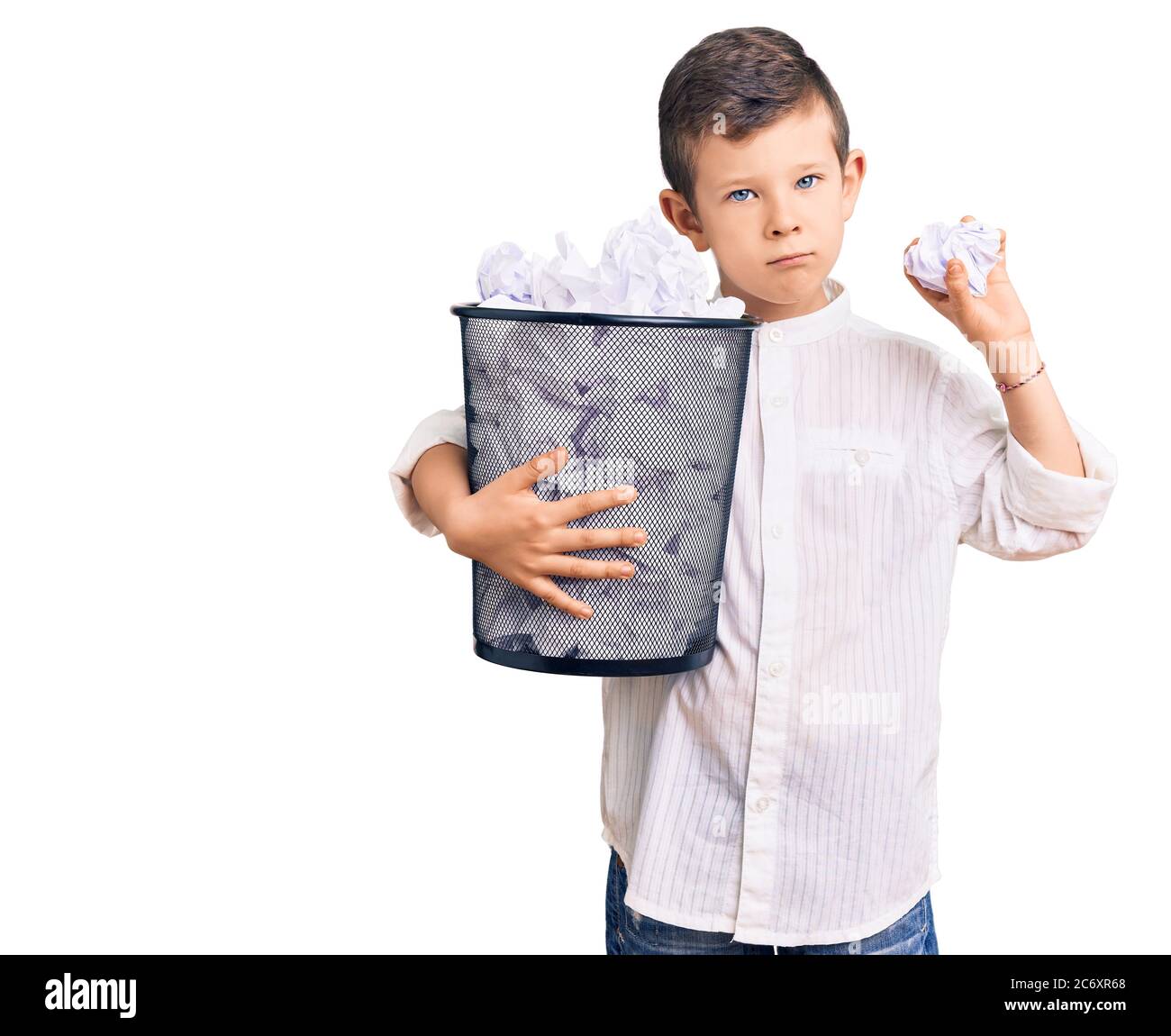 Cute blond kid holding paper bin full of crumpled papers thinking ...