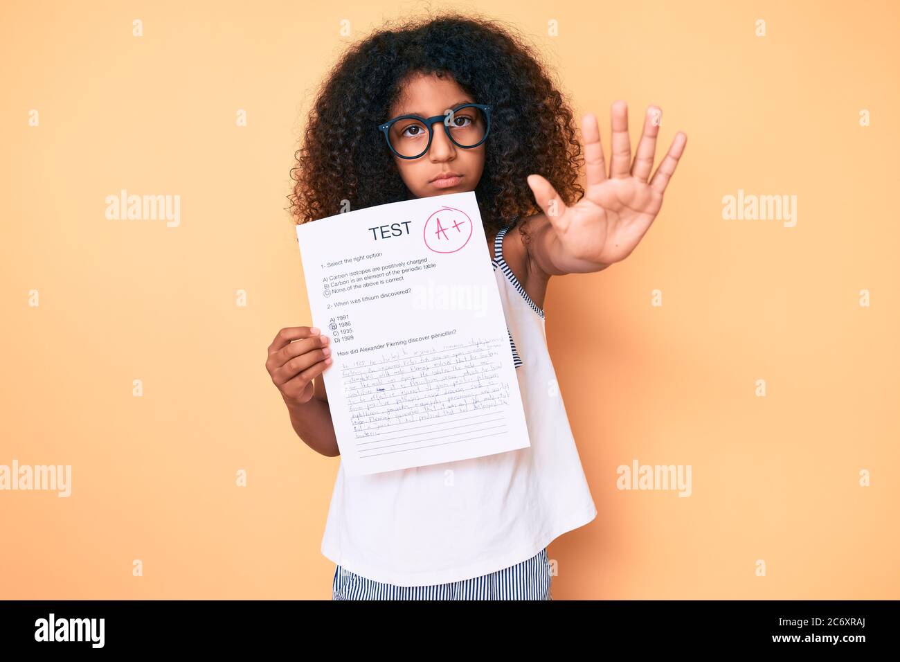 African american child with curly hair wearing glasses showing a passed ...