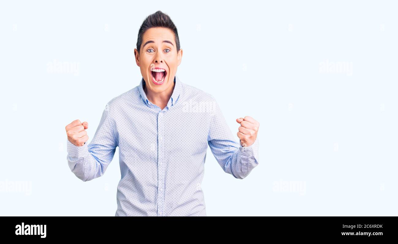 Young woman with short hair wearing business clothes celebrating ...