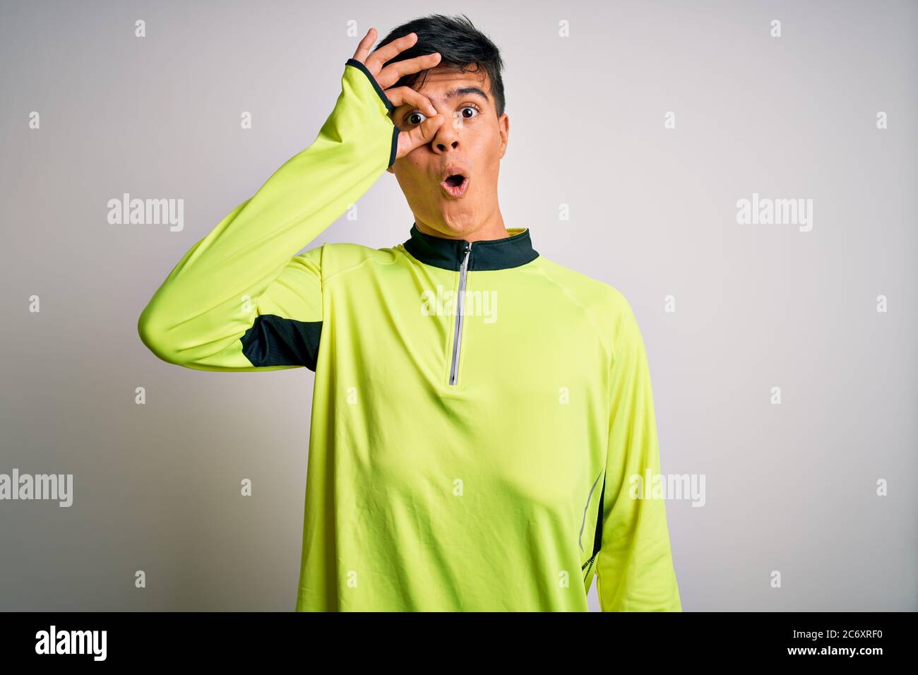 Young handsome sportsman doing sport wearing sportswear over isolated ...
