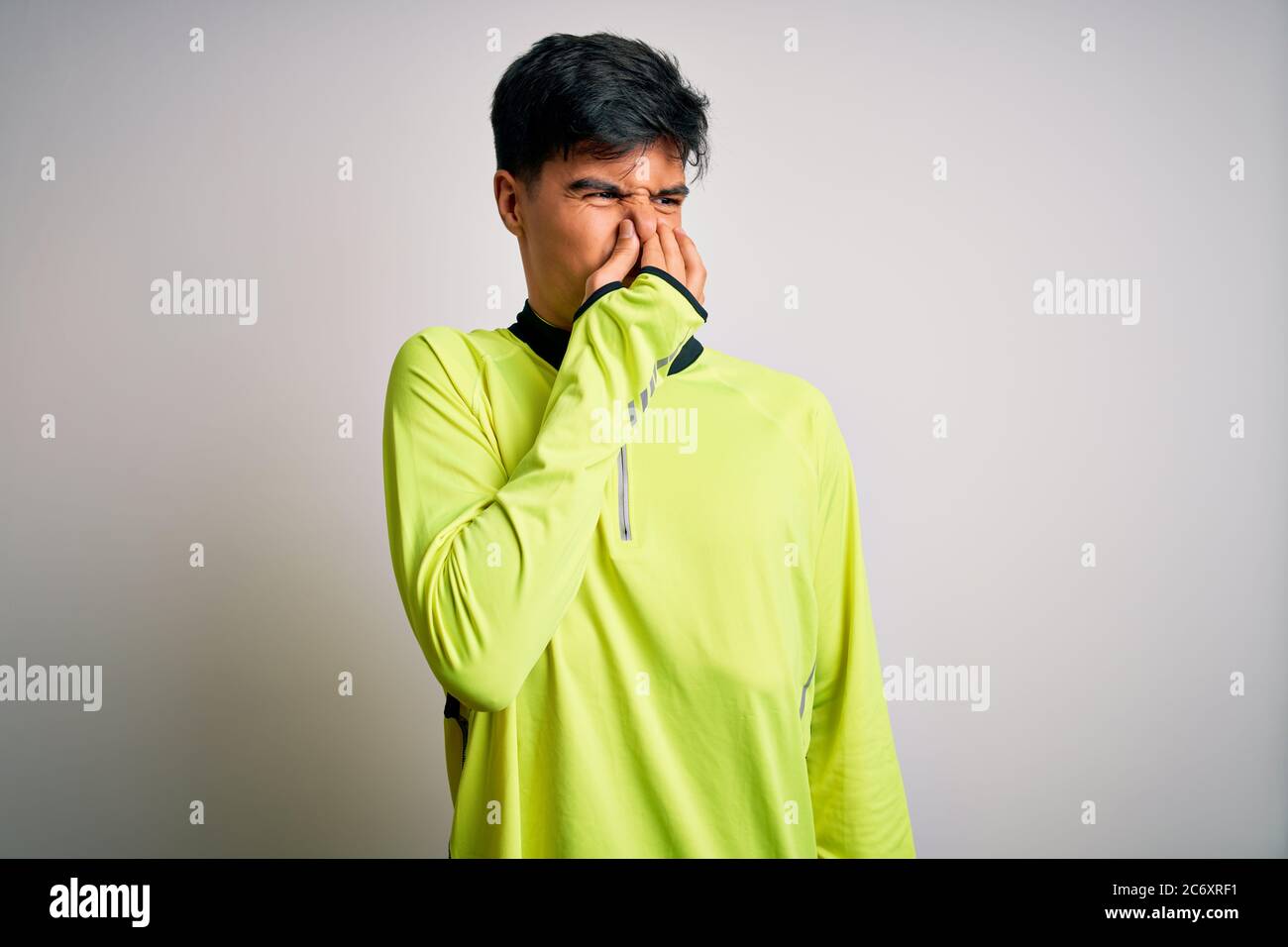 Young handsome sportsman doing sport wearing sportswear over isolated ...