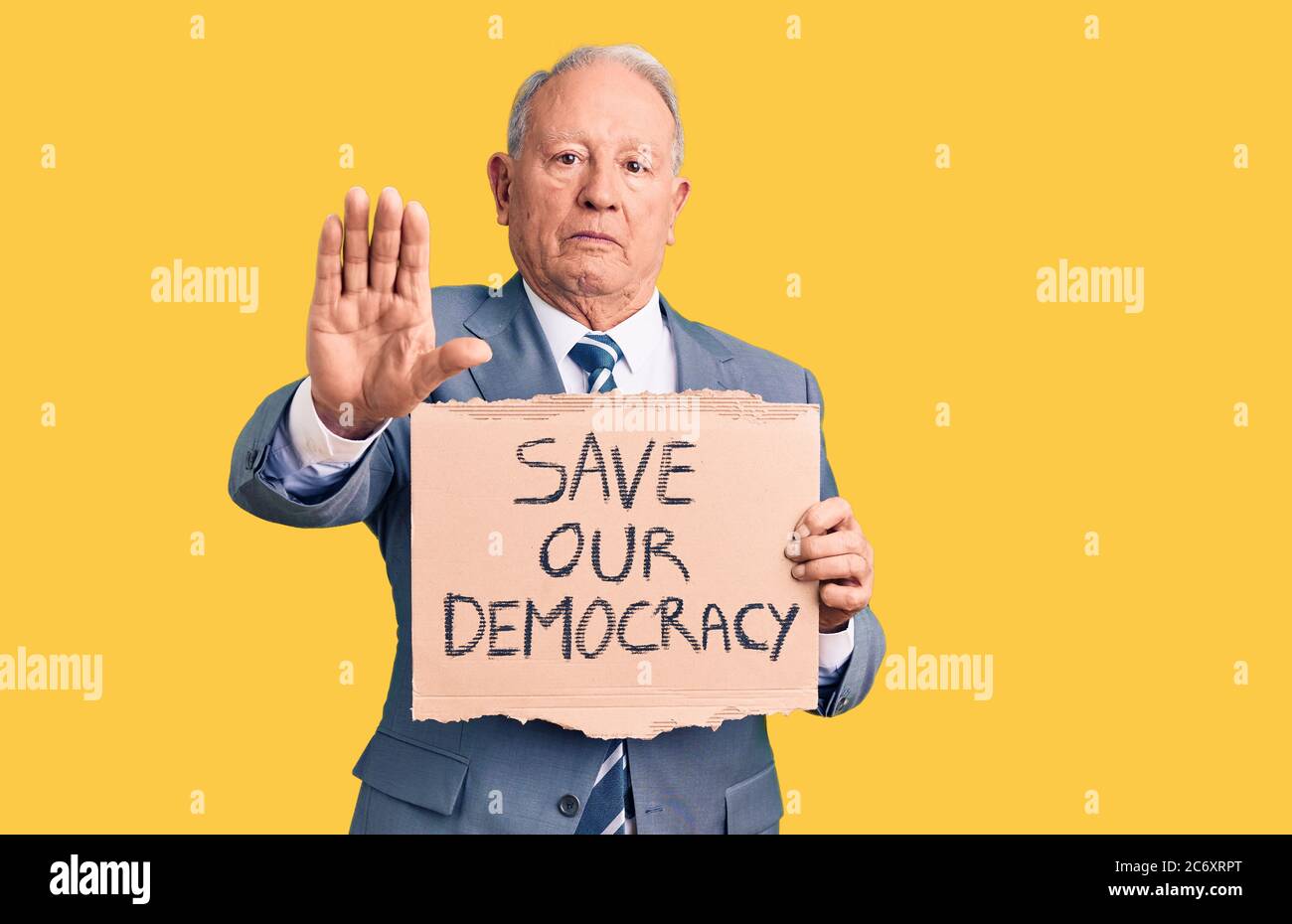 Senior handsome grey-haired man holding save our democracy cardboard ...