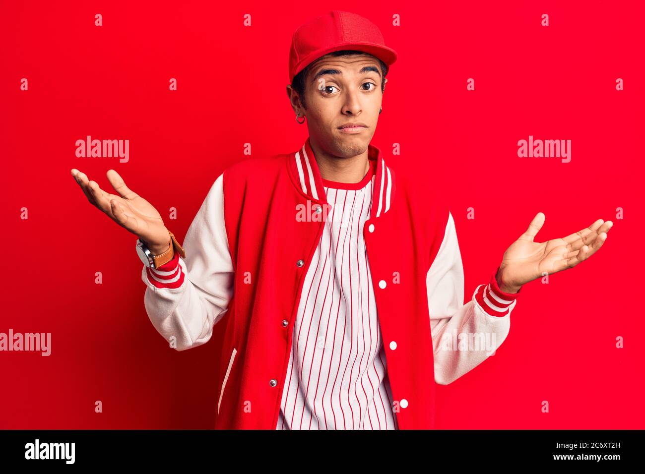 Young african amercian man wearing baseball uniform clueless and ...