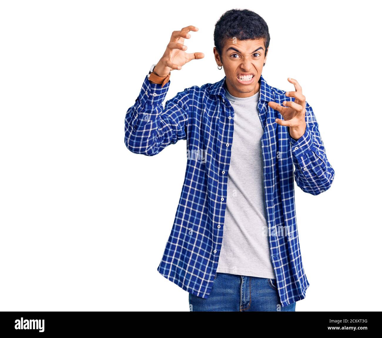 Young african amercian man wearing casual clothes shouting frustrated ...