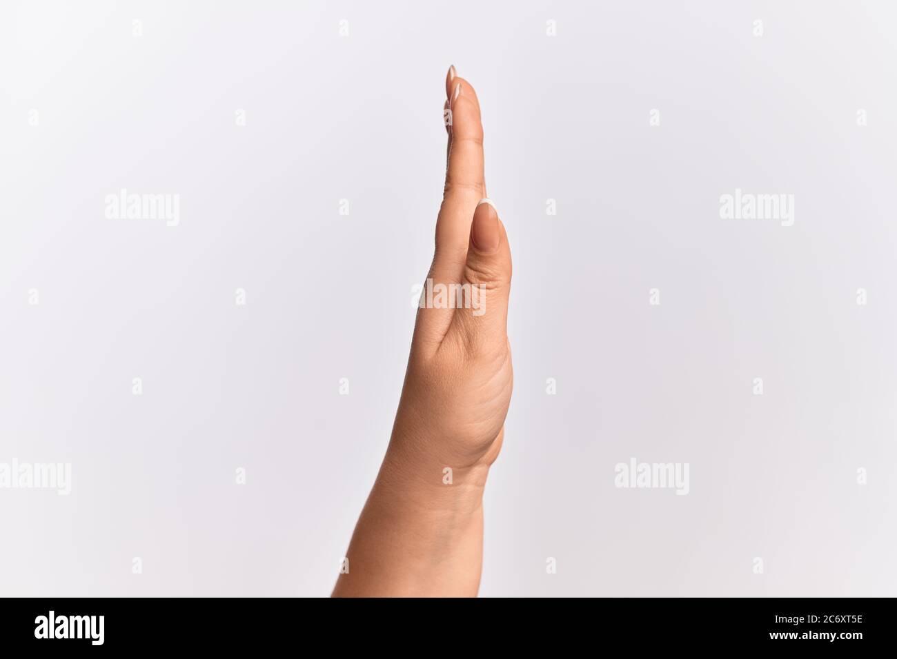 Hand of caucasian young woman showing side of stretched hand, pushing ...