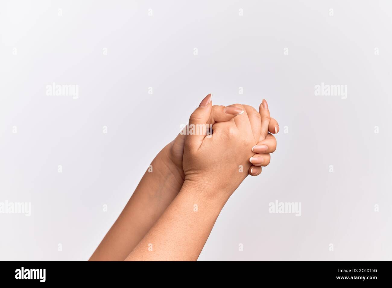 Hand of caucasian young woman with both hands crossed together showing ...