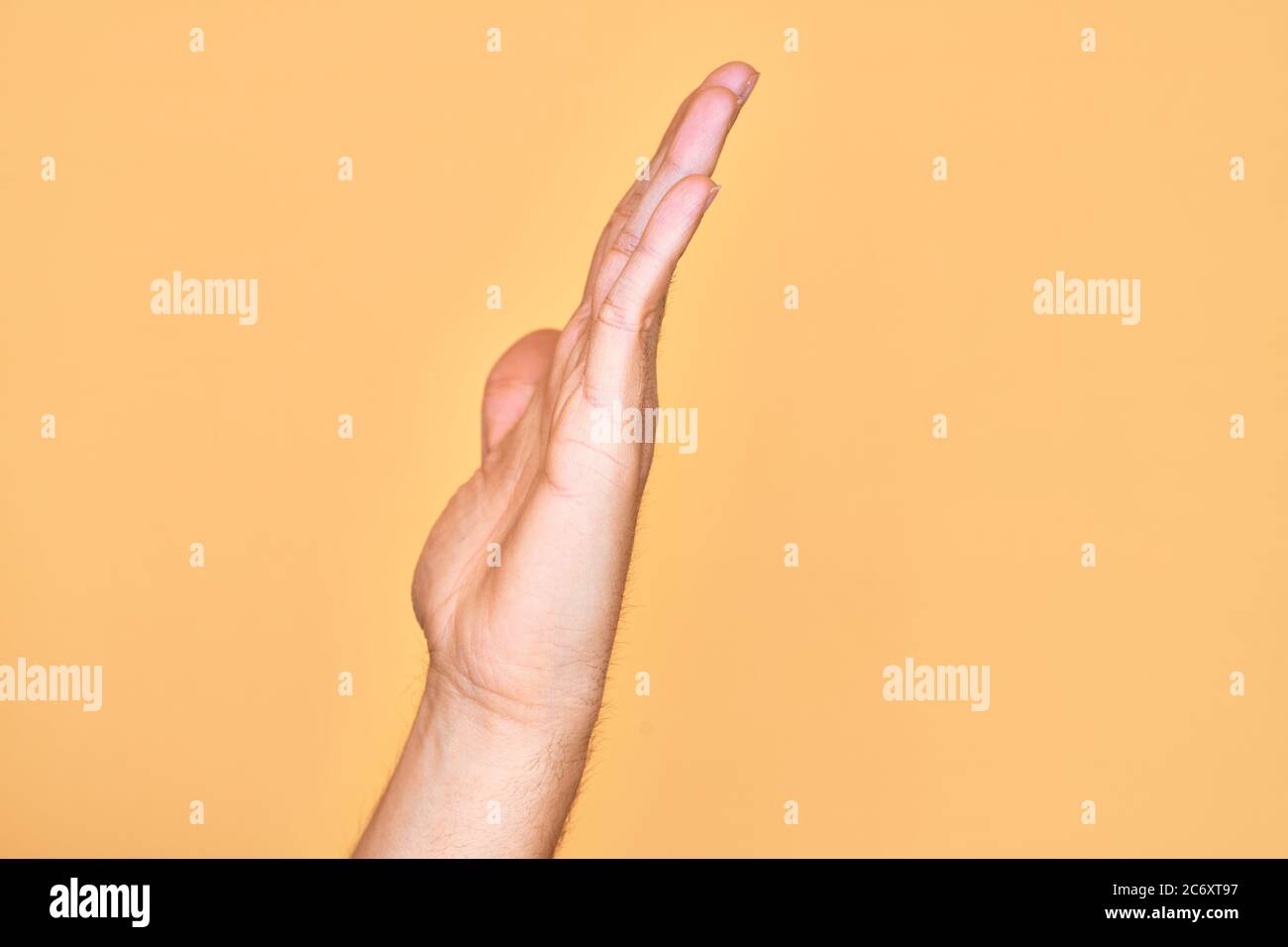 Hand of caucasian young man showing fingers over isolated yellow ...