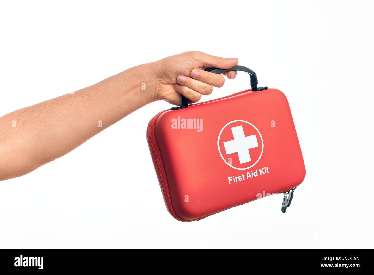 Hand of caucasian young man holding first aid kit over isolated white ...