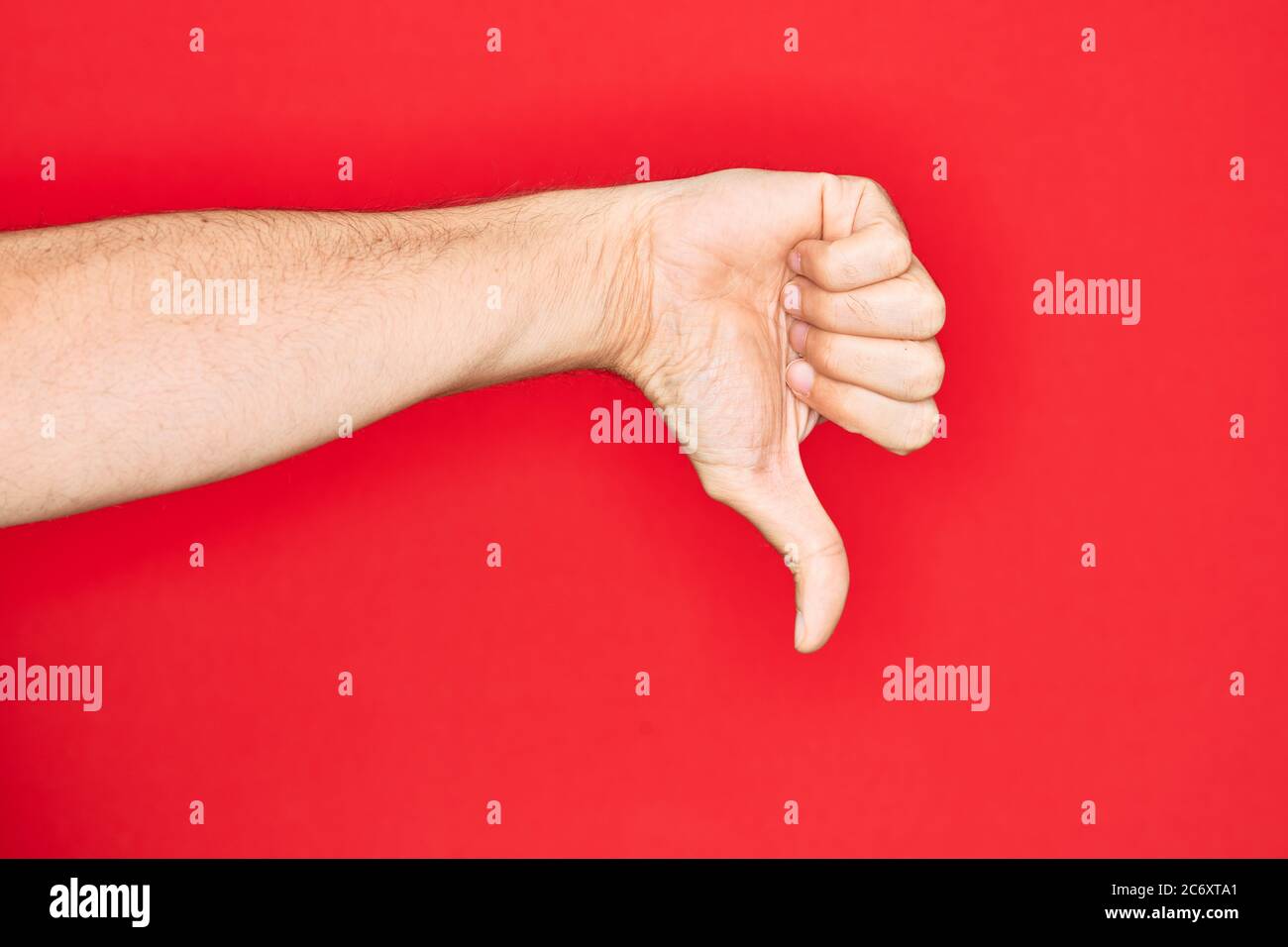Hand of caucasian young man showing fingers over isolated red ...