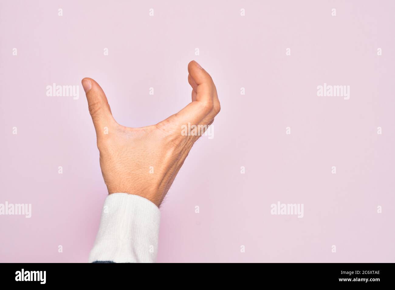 Hand of caucasian young man showing fingers over isolated pink ...