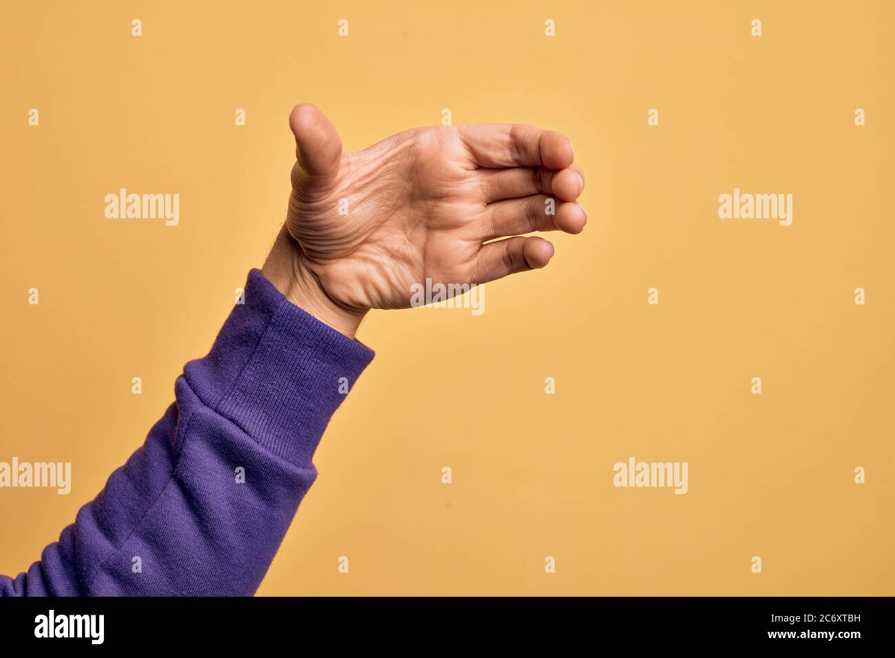 Hand of caucasian young man showing fingers over isolated yellow ...