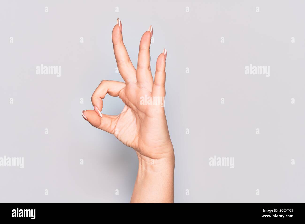 Hand of caucasian young woman gesturing approval expression doing okay ...
