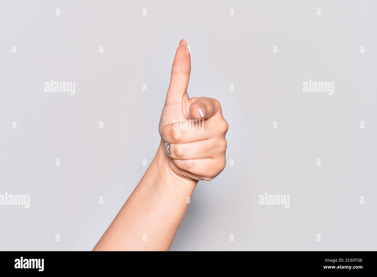 Hand of caucasian young woman pointing forefinger to the camera ...