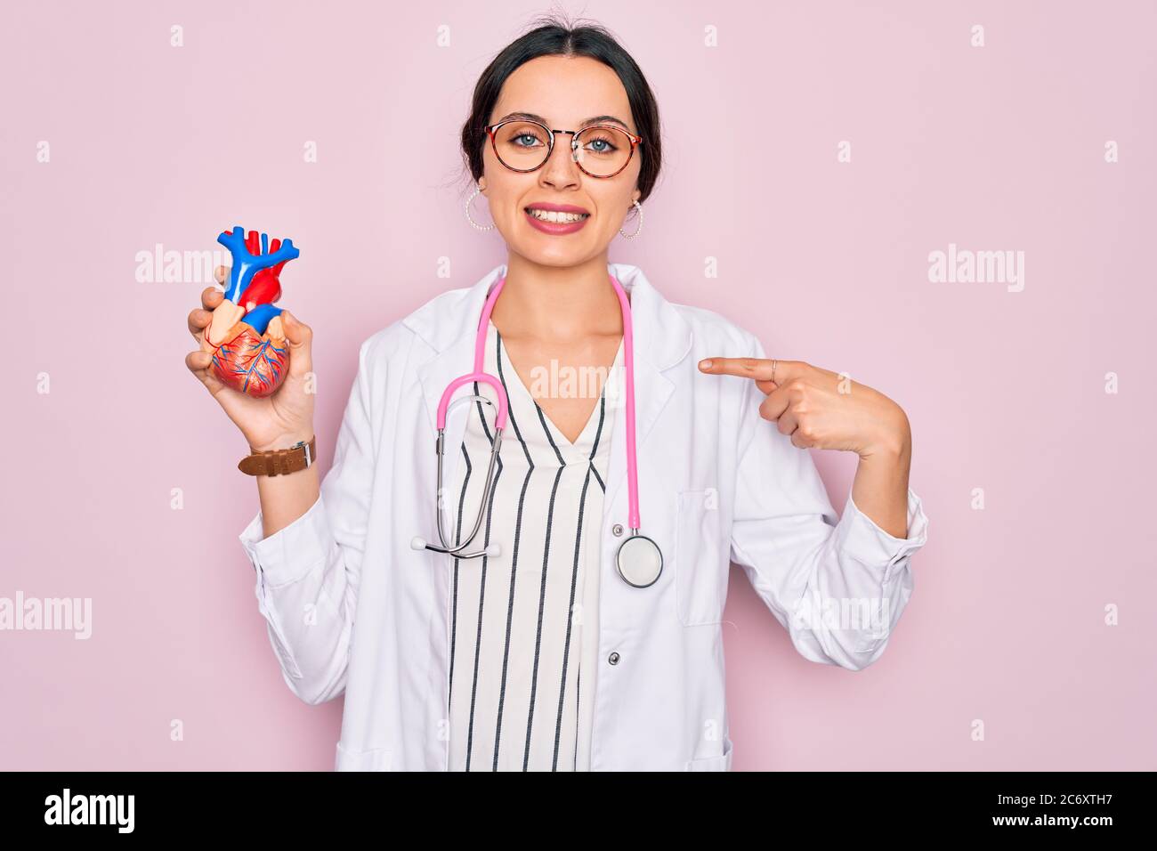 Young beautiful cardiologist woman with blue eyes wearing stethoscope ...