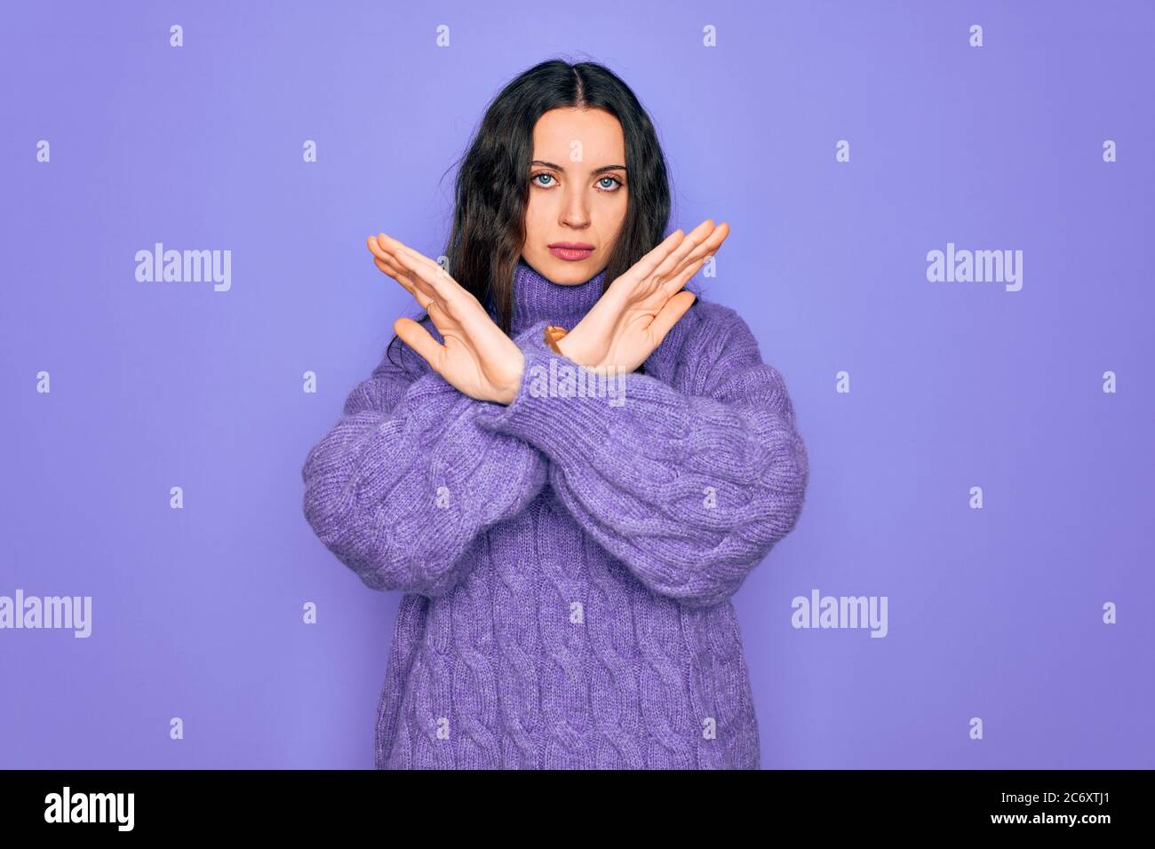 Young beautiful woman wearing casual turtleneck sweater standing over ...