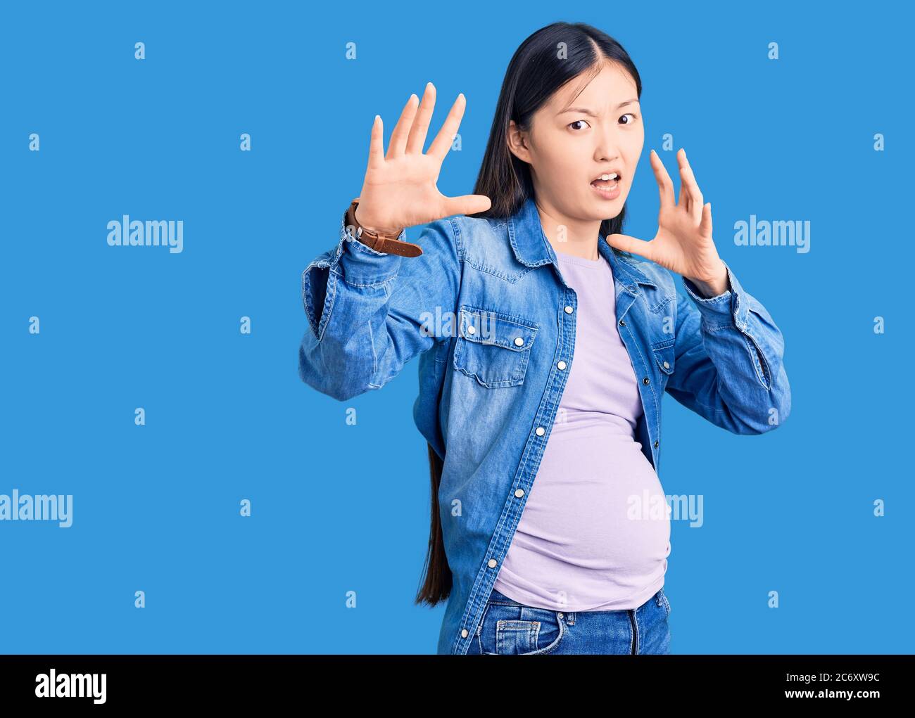 Young beautiful chinese woman pregnant expecting baby afraid and ...