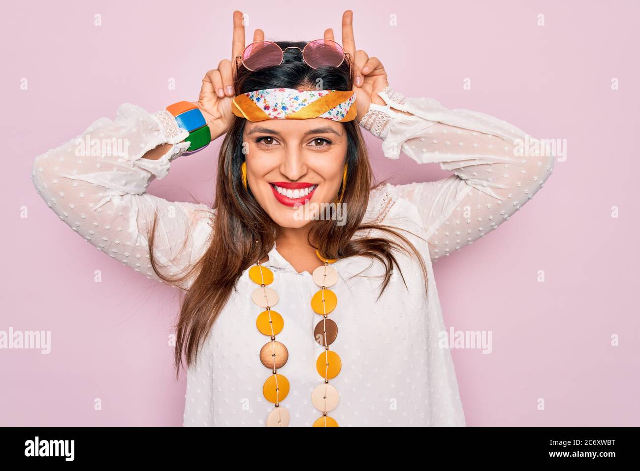 Young hispanic hippie woman wearing fashion boho style and sunglasses ...