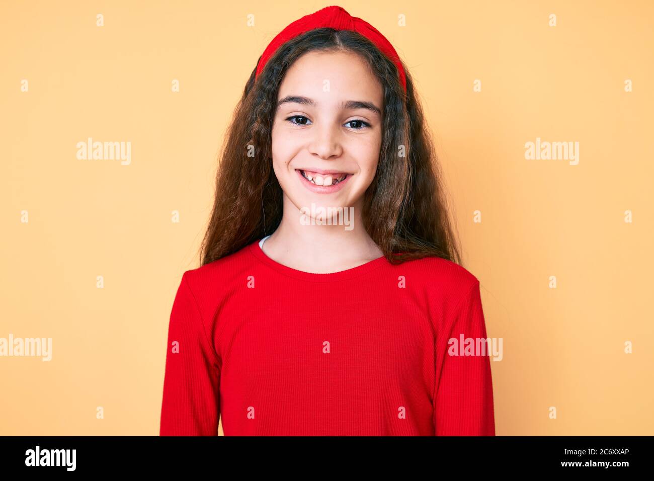 Cute hispanic child girl wearing casual clothes and diadem with a happy ...
