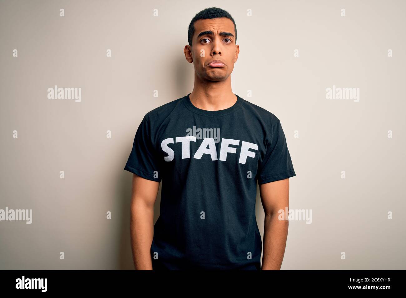 Young handsome african american worker man wearing staff uniform over ...
