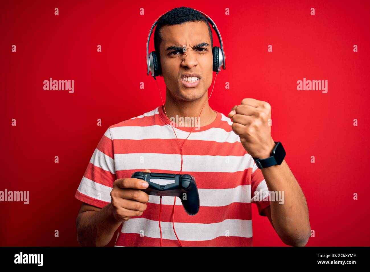 Handsome african american gamer man playing video game using jostick ...