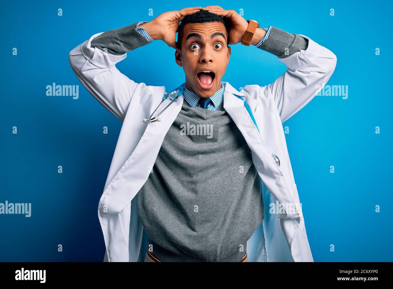 Handsome african american doctor man wearing coat and stethoscope over ...