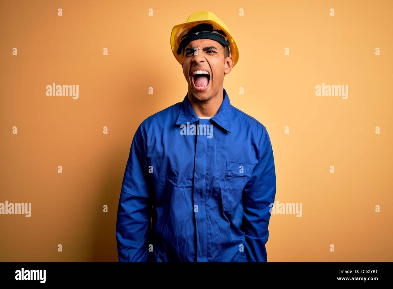 Young handsome african american worker man wearing blue uniform and ...