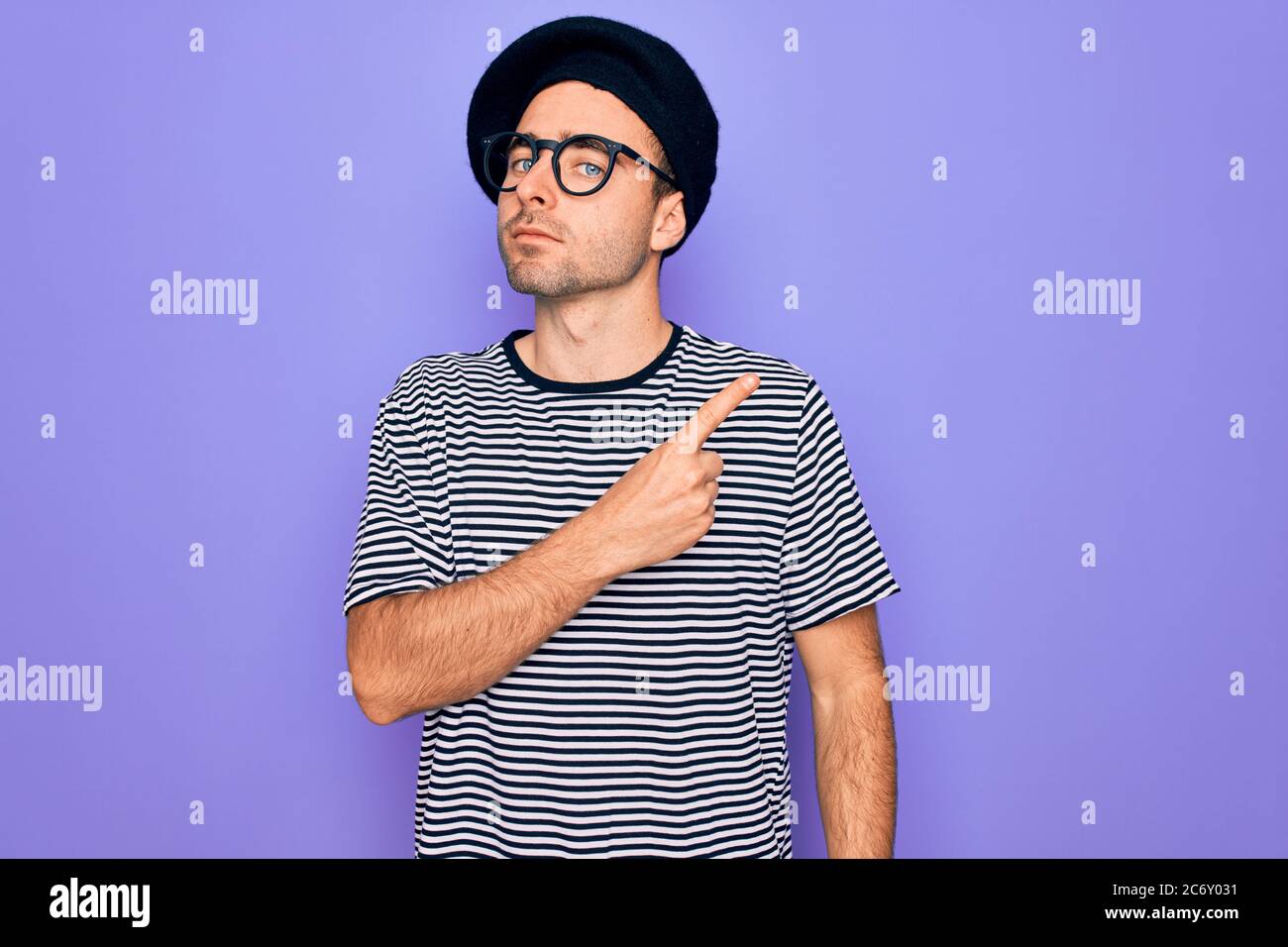Handsome man with blue eyes wearing striped t-shirt and french beret ...